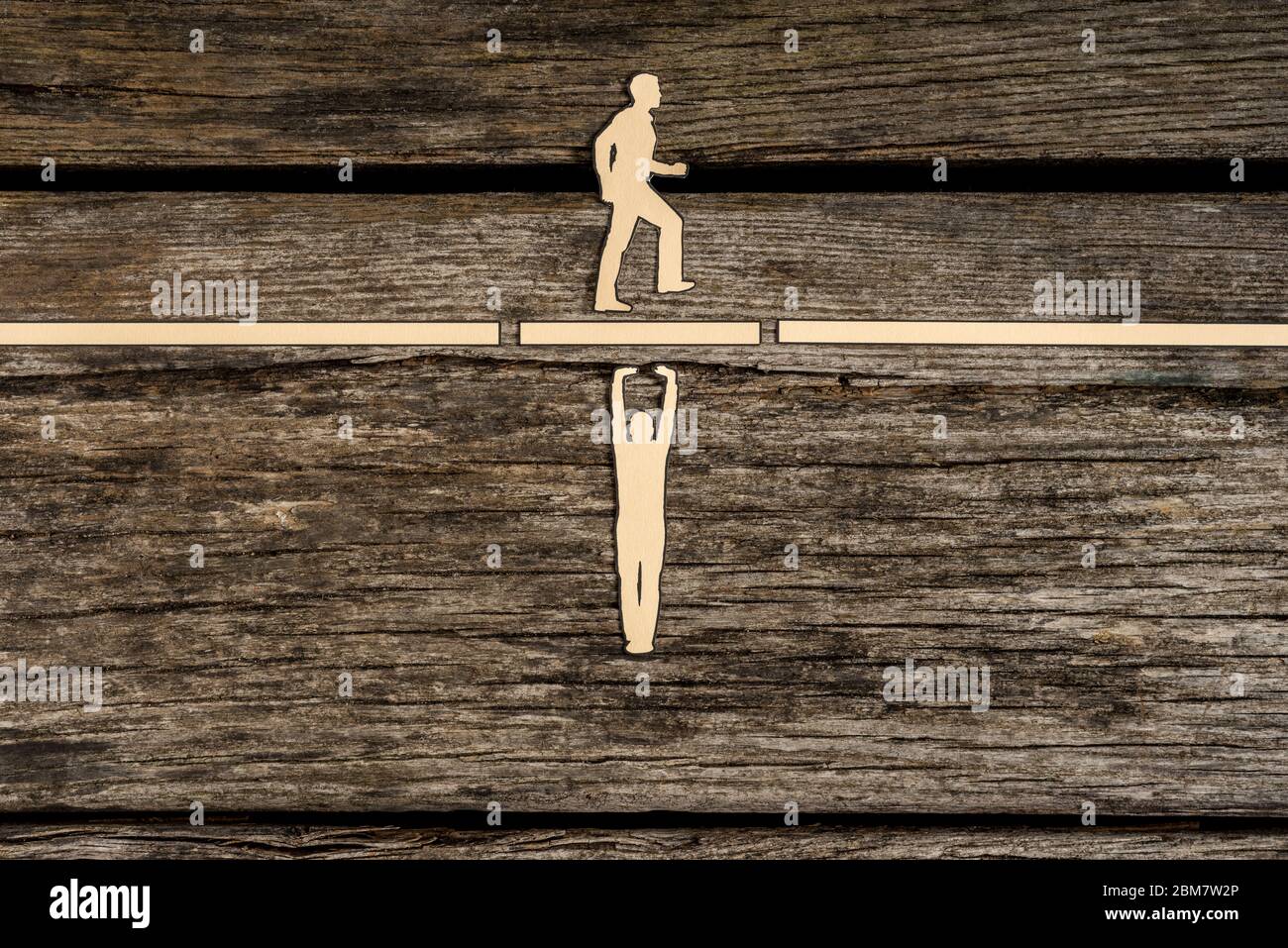 Teamwork concept using paper cut outs of men with one holding up a ...