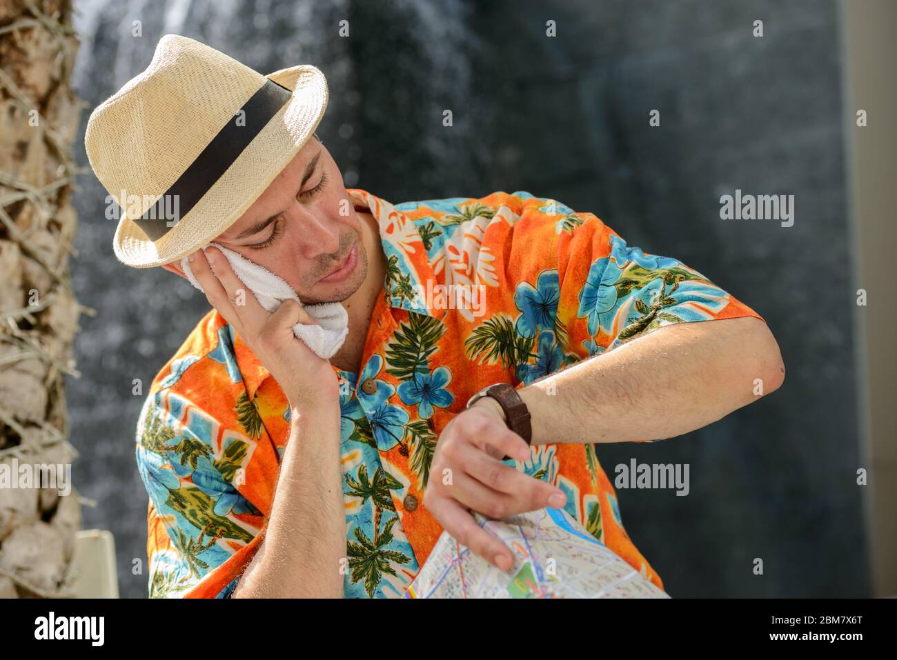 Stressed young tourist man feeling hot in the city outdoors Stock Photo ...