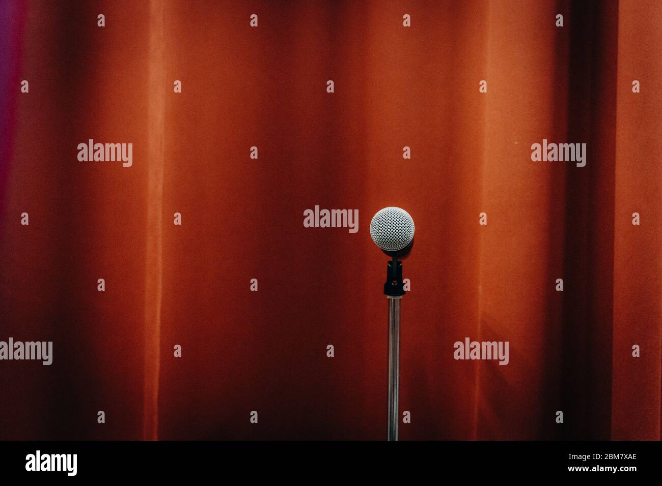 microphone in front of a red curtain Stock Photo - Alamy