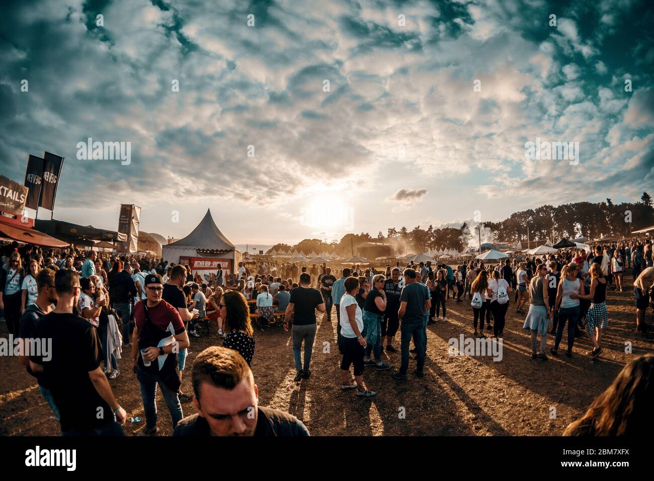 festival crowd with cloudy sky Stock Photo - Alamy