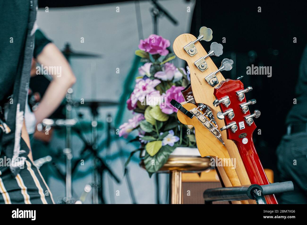 Guitar with flowers on stage Stock Photo - Alamy