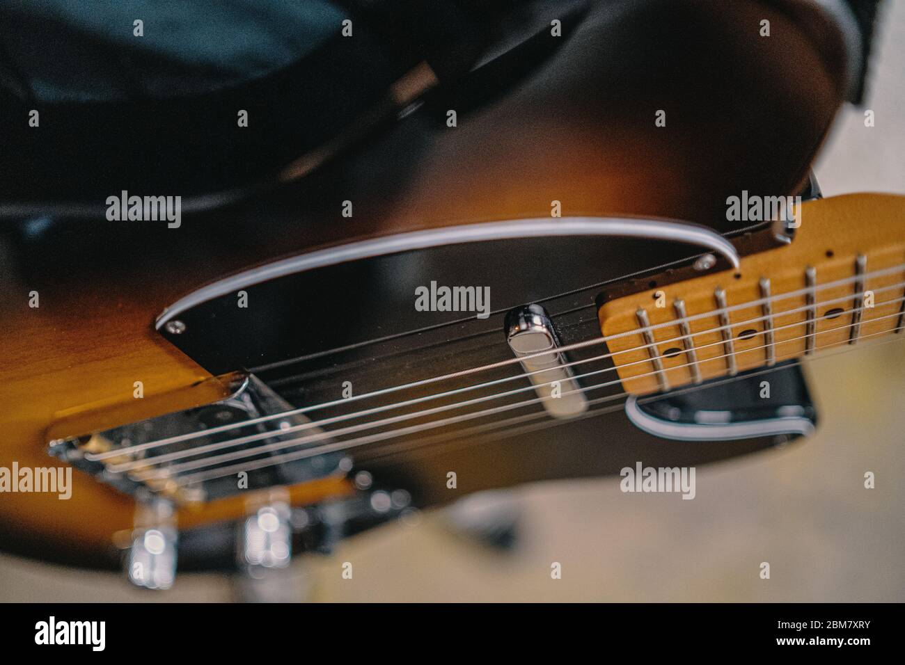 The guitar sits on the concert stage, its sleek and polished body ...