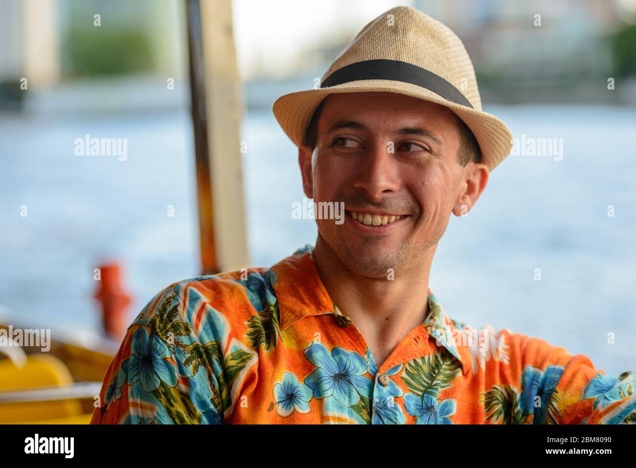 Happy young tourist man smiling while riding boat on the river Stock ...