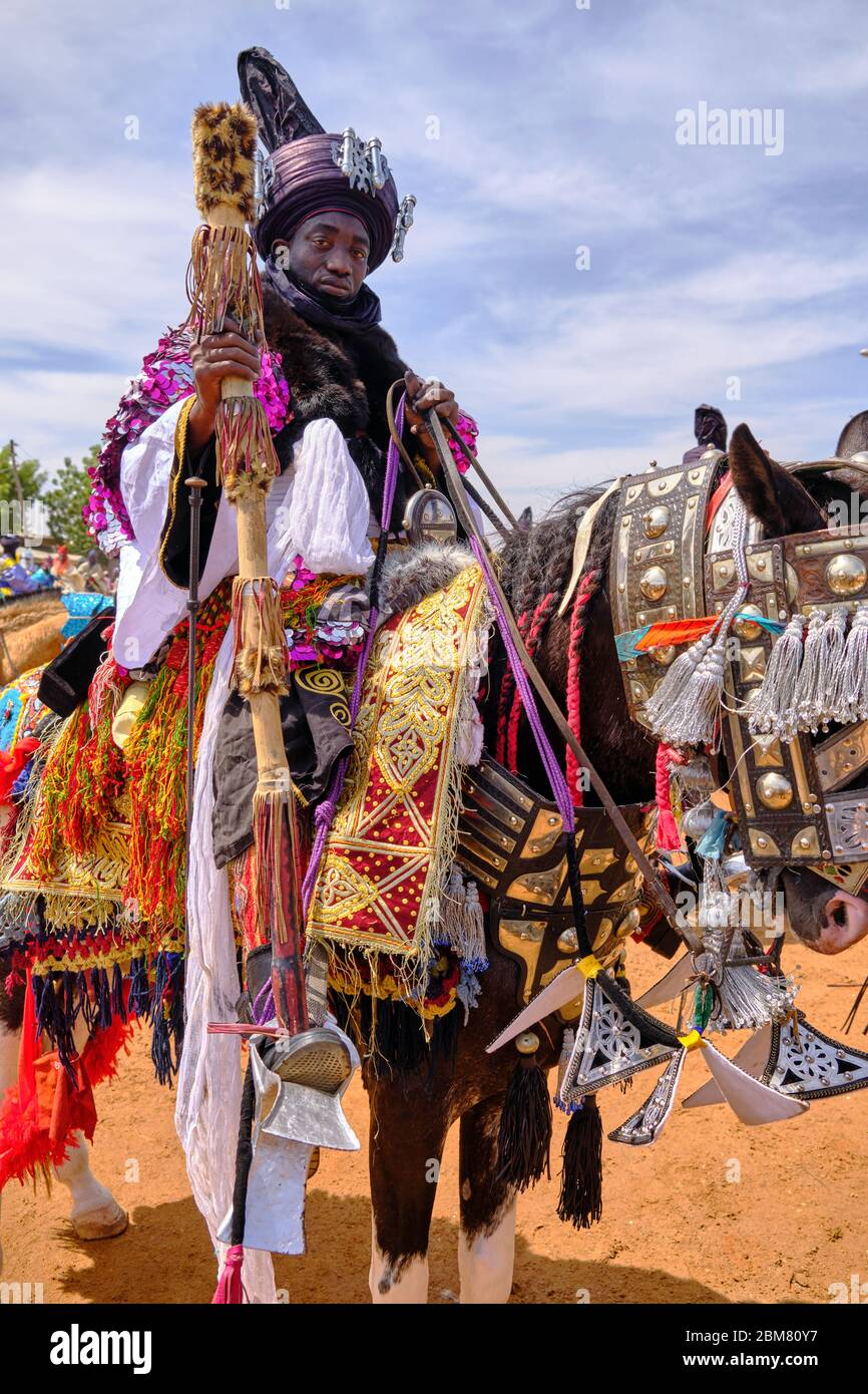 Nobleman rider dressed in a colourful outfit mounting an embellished ...