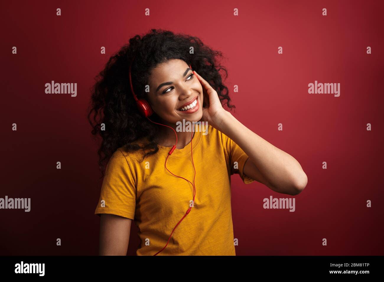Photo of happy positive optimistic young african woman posing isolated ...