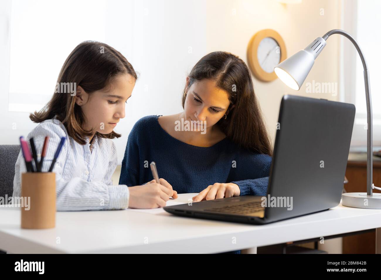 Teen girl giving private lessons to a girl Stock Photo - Alamy