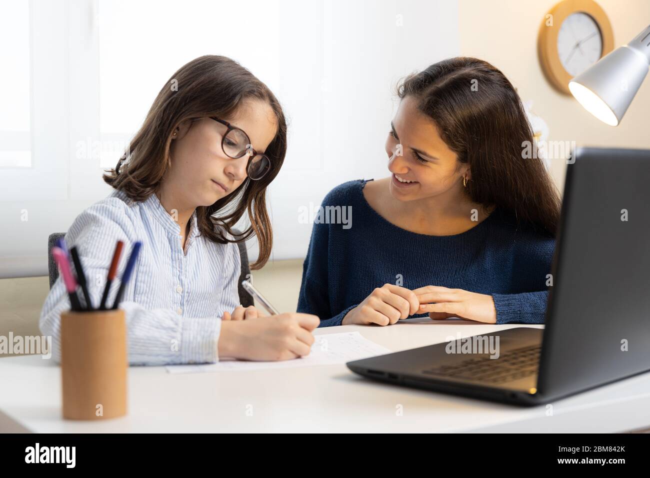 Teen girl giving private lessons to a girl Stock Photo - Alamy
