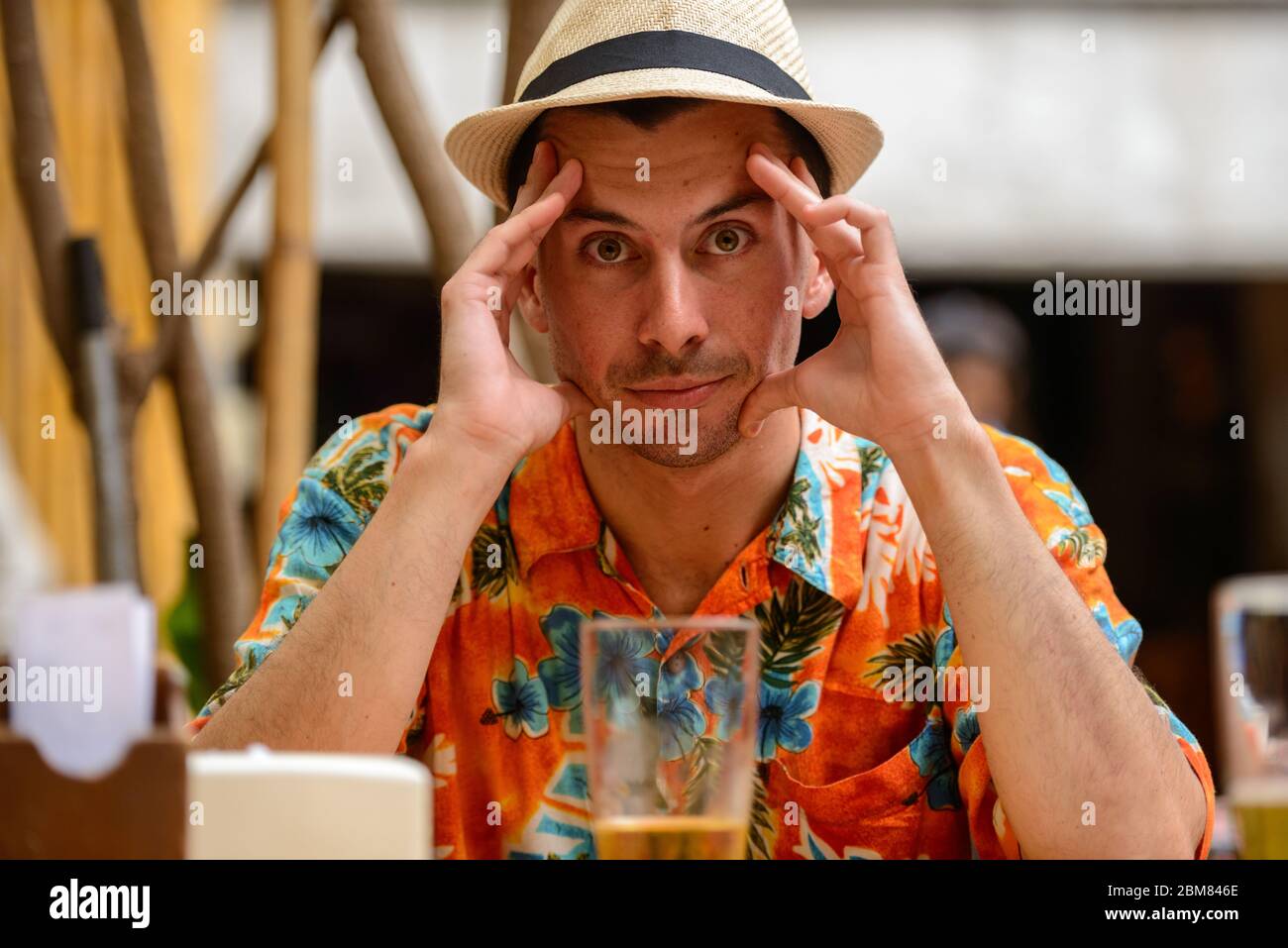 Stressed young tourist man having headache at the restaurant Stock ...