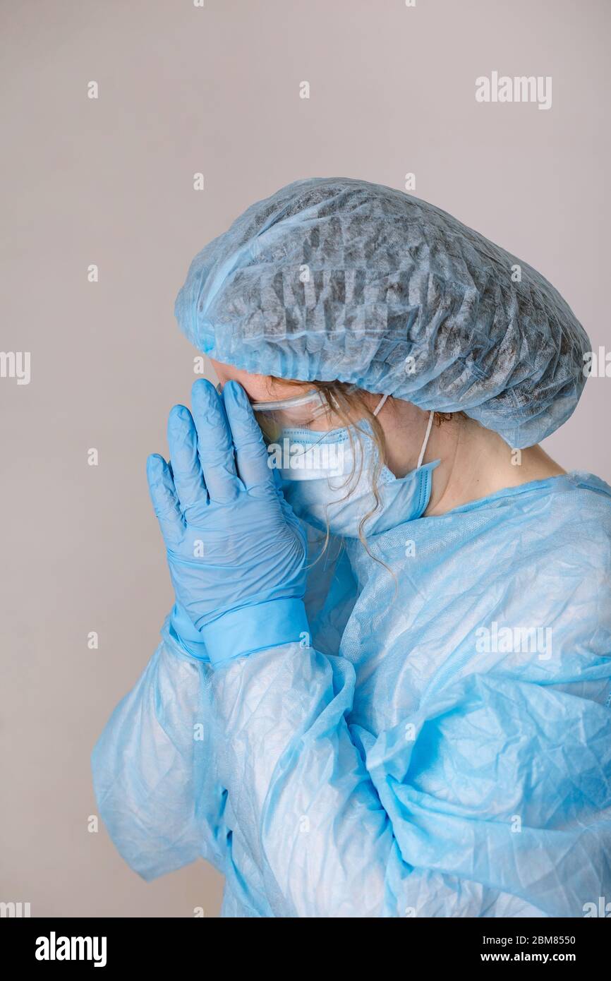 Praying tired doctor nurse hi-res stock photography and images - Alamy