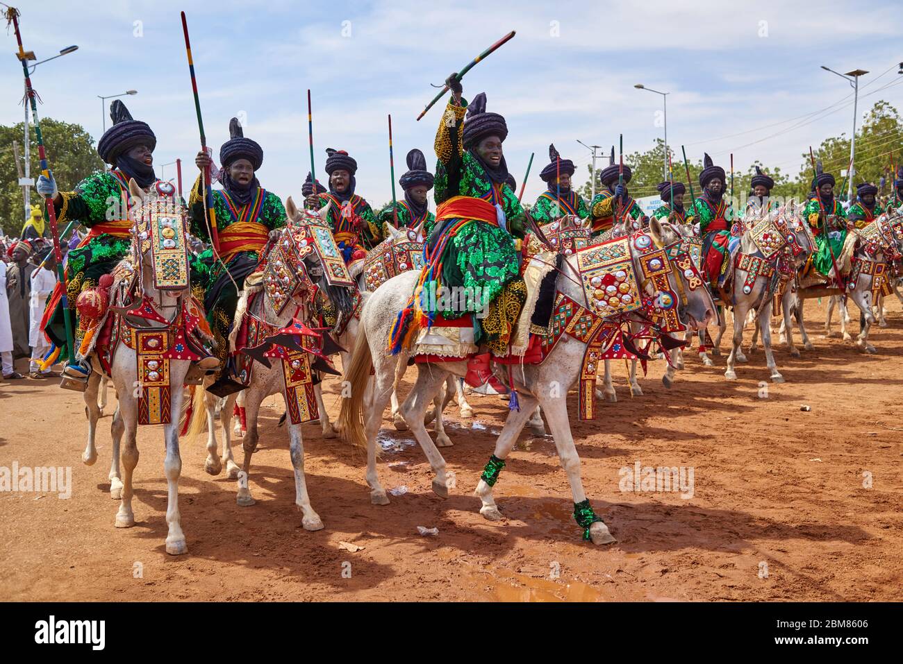 Noblemen riders dressed in a colourful outfit mounting embellished ...