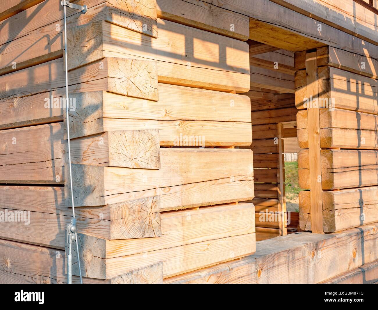 Steel wire of lightning conductor on wooden wall. Root wire lightning ...