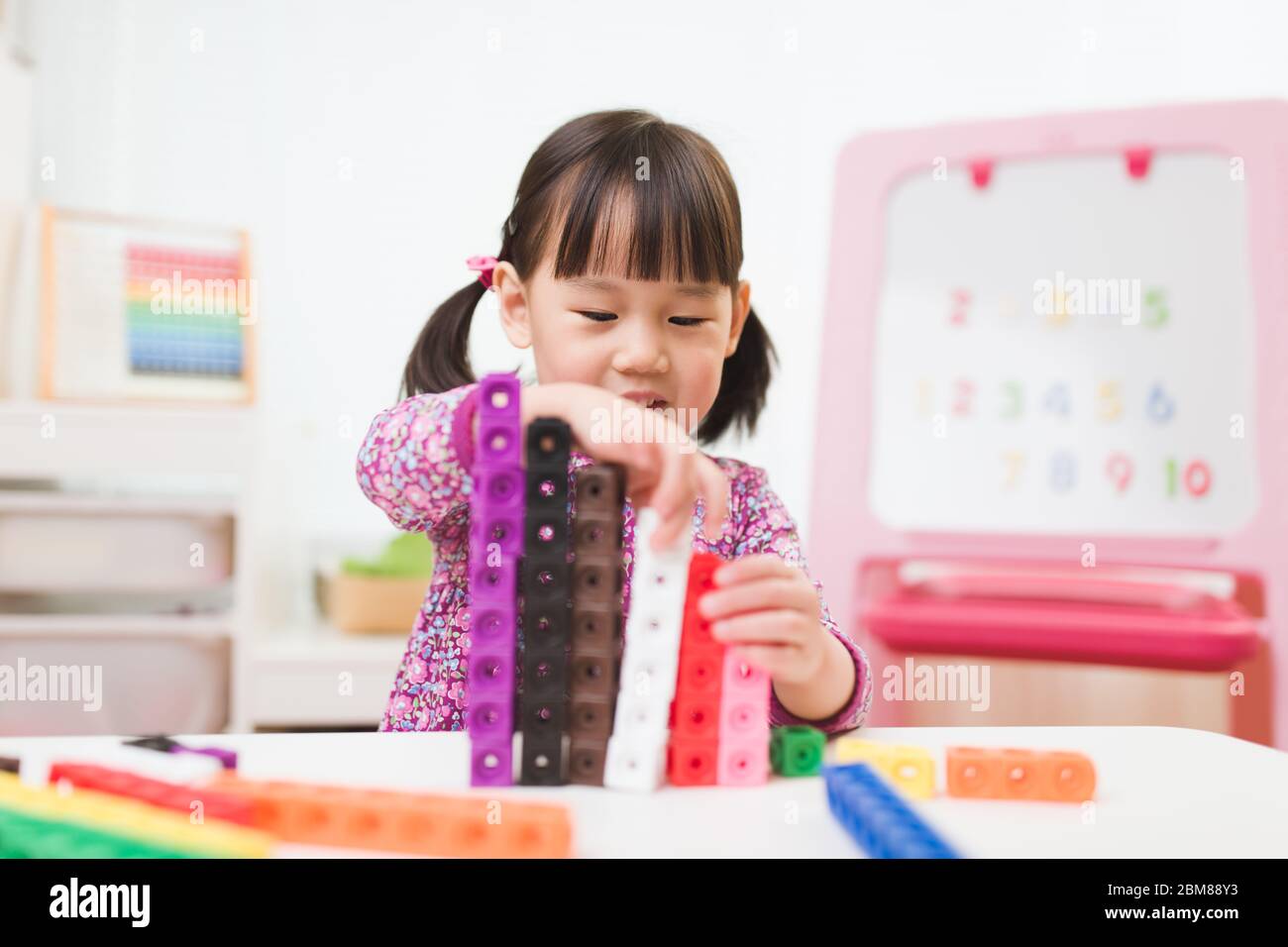 toddler girl play number blocks for homeschooling Stock Photo - Alamy