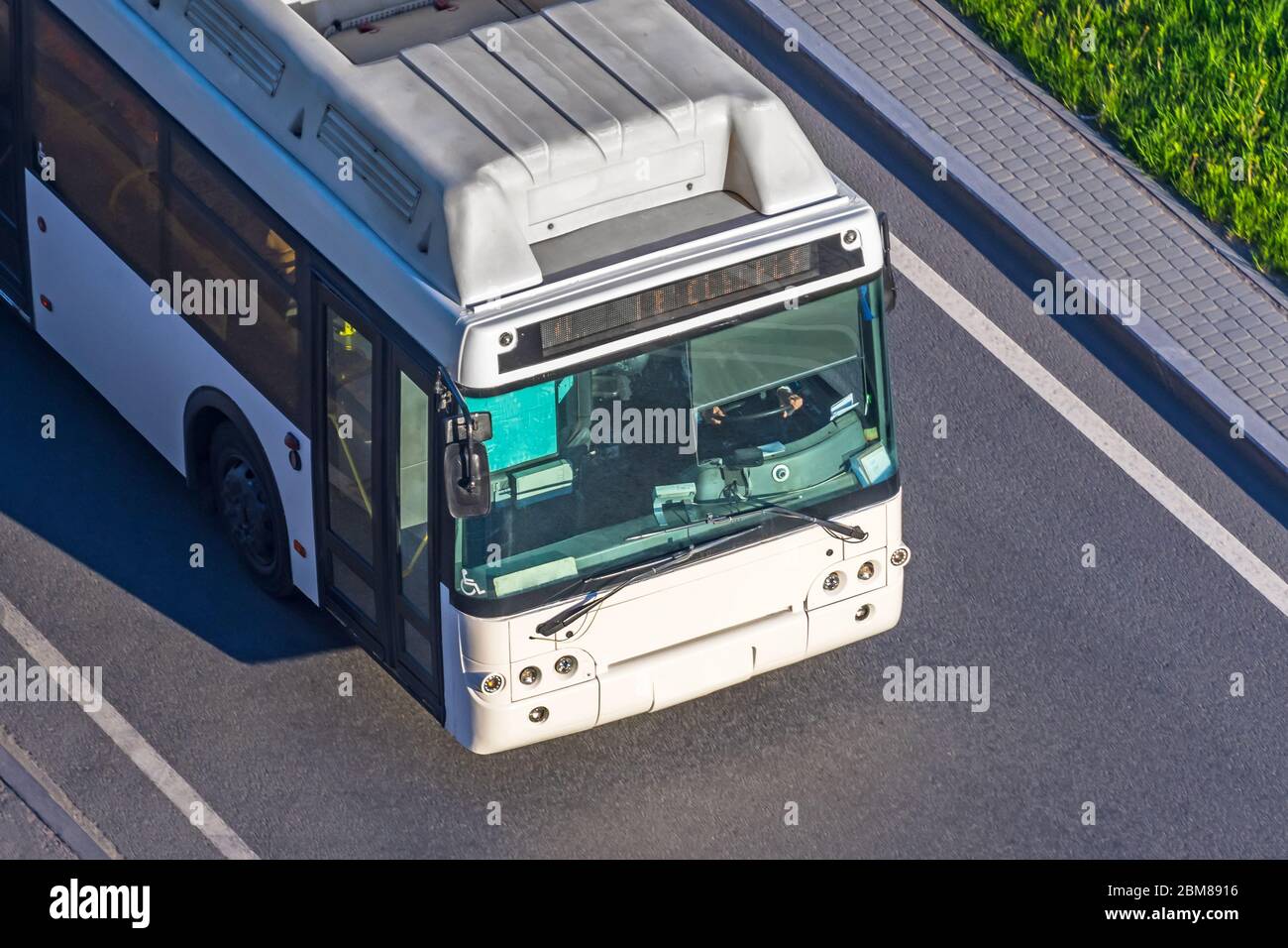 View from above on a white passenger city bus, a cabin and a drivers ...