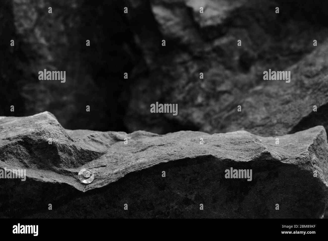 A Single Diamond on the Top of a Rock Crevice with a Blurred Mineral ...