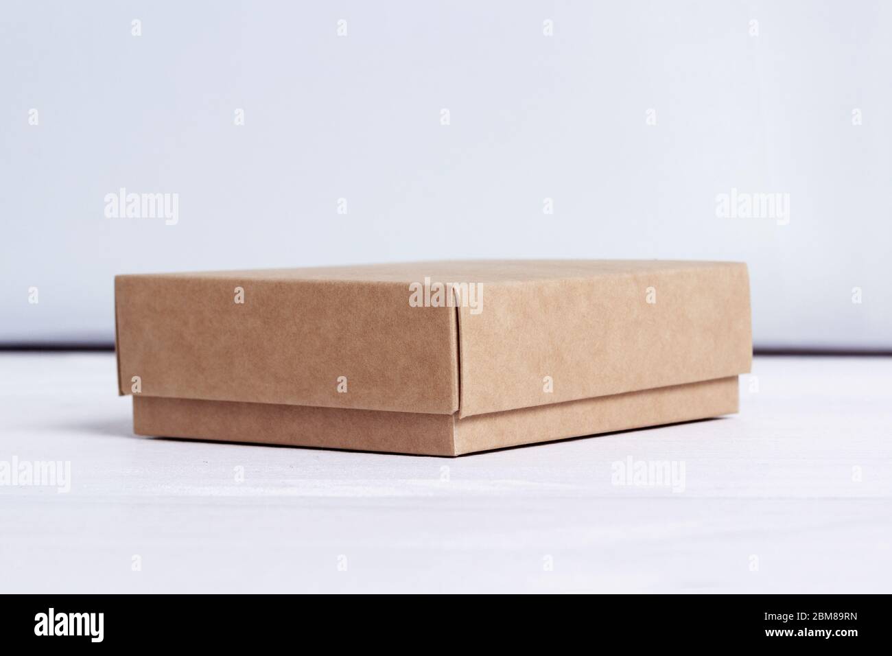 Cardboard box. Package isolated on white wood background. Craft paper ...