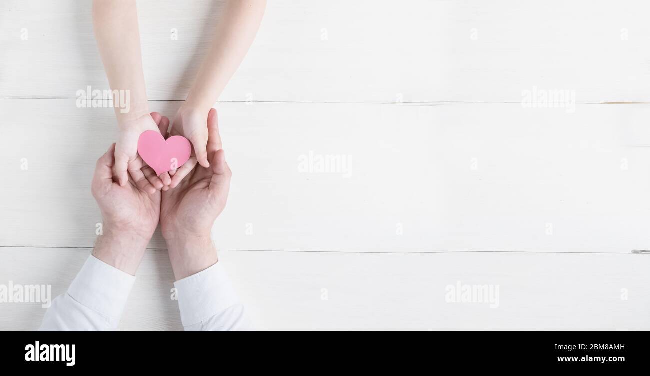 Happy father's day.Greeting card.Heart in the hands of daughter and ...