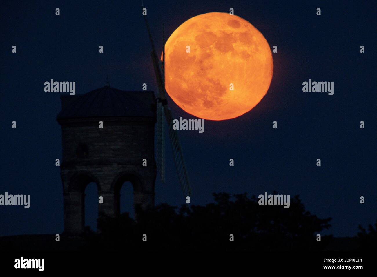 The full moon, also known as the Supermoon or Flower Moon, rises over ...