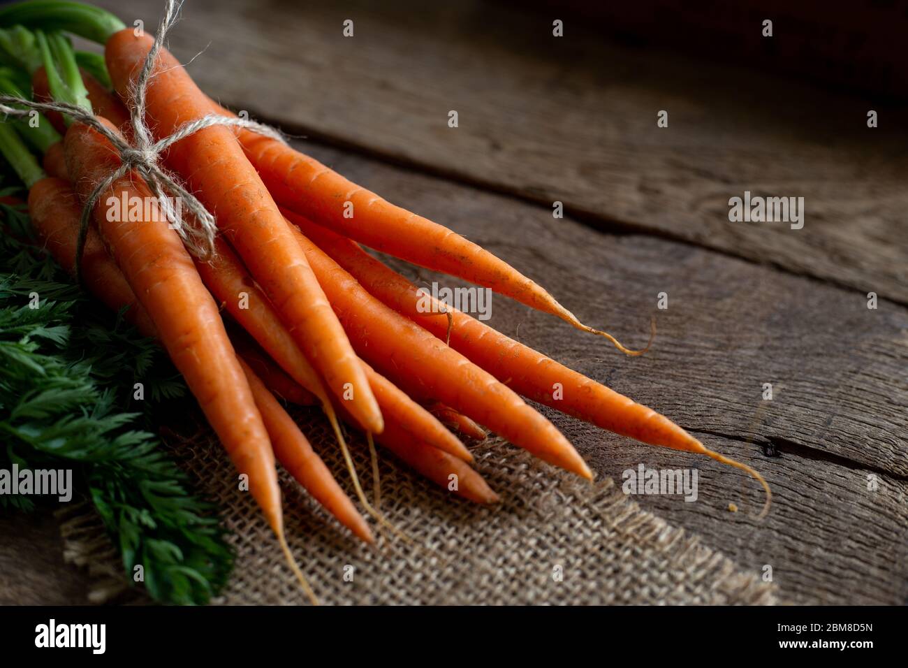 Fresh organic carrots on antique wooden table, soft focus Stock Photo ...