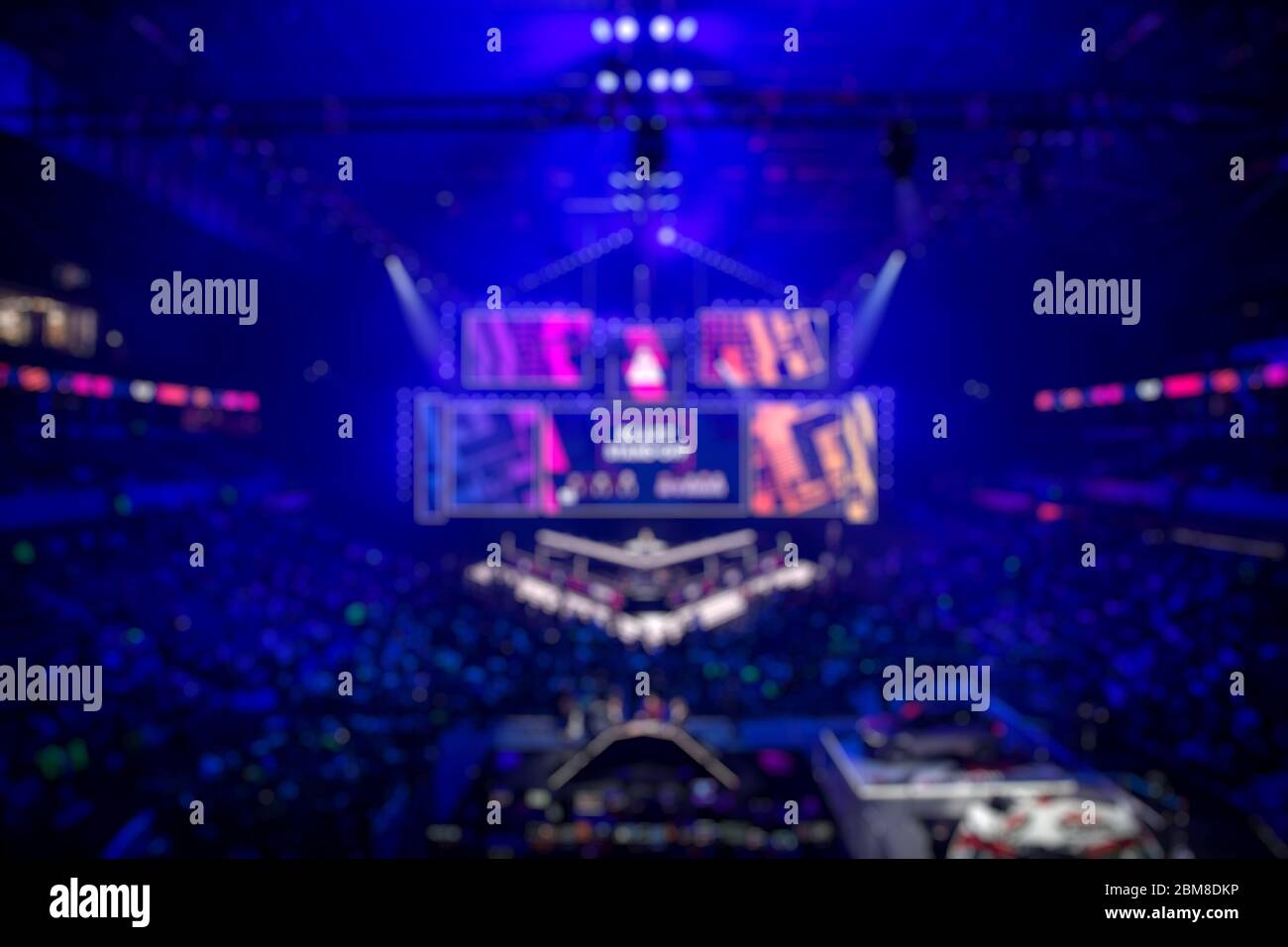 Blurred background of an esports event - big illuminated main stage of ...