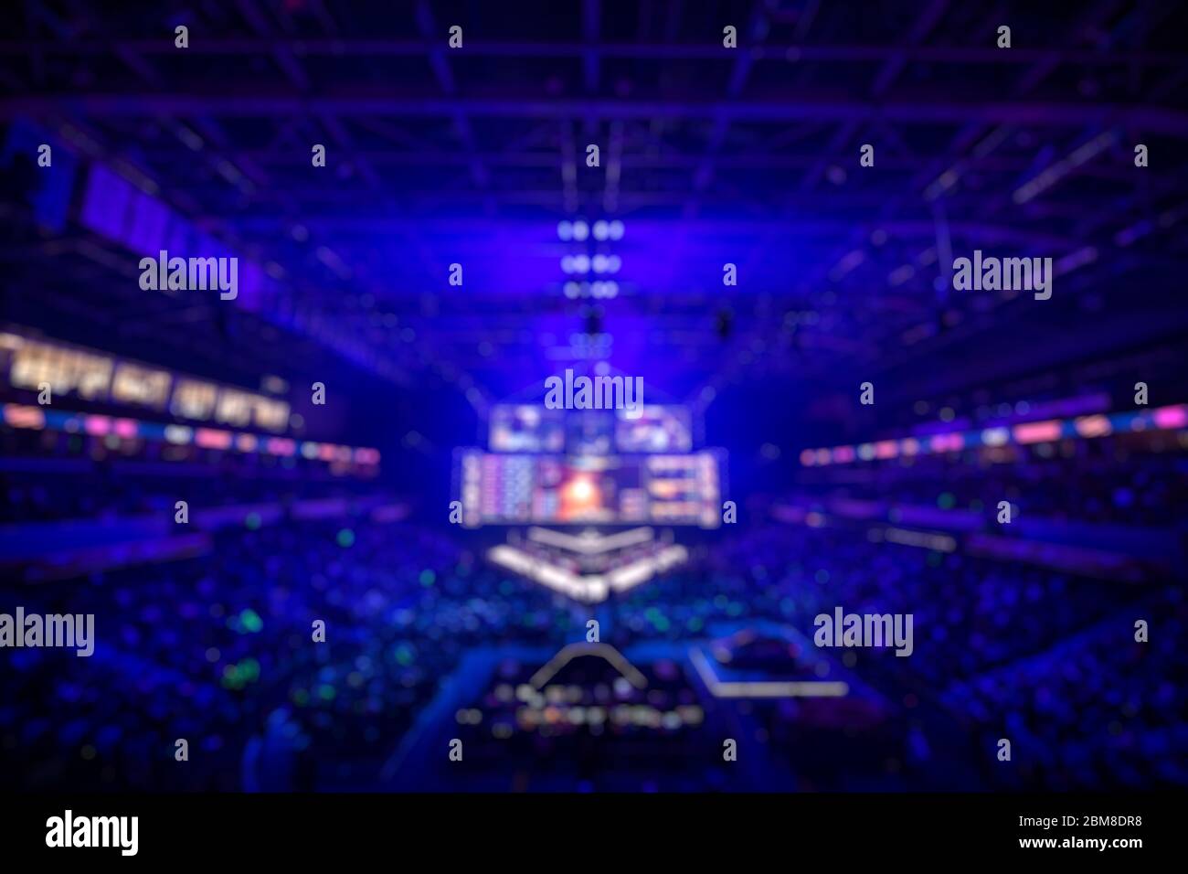 Blurred background of an esports event - Big illuminated main stage of ...