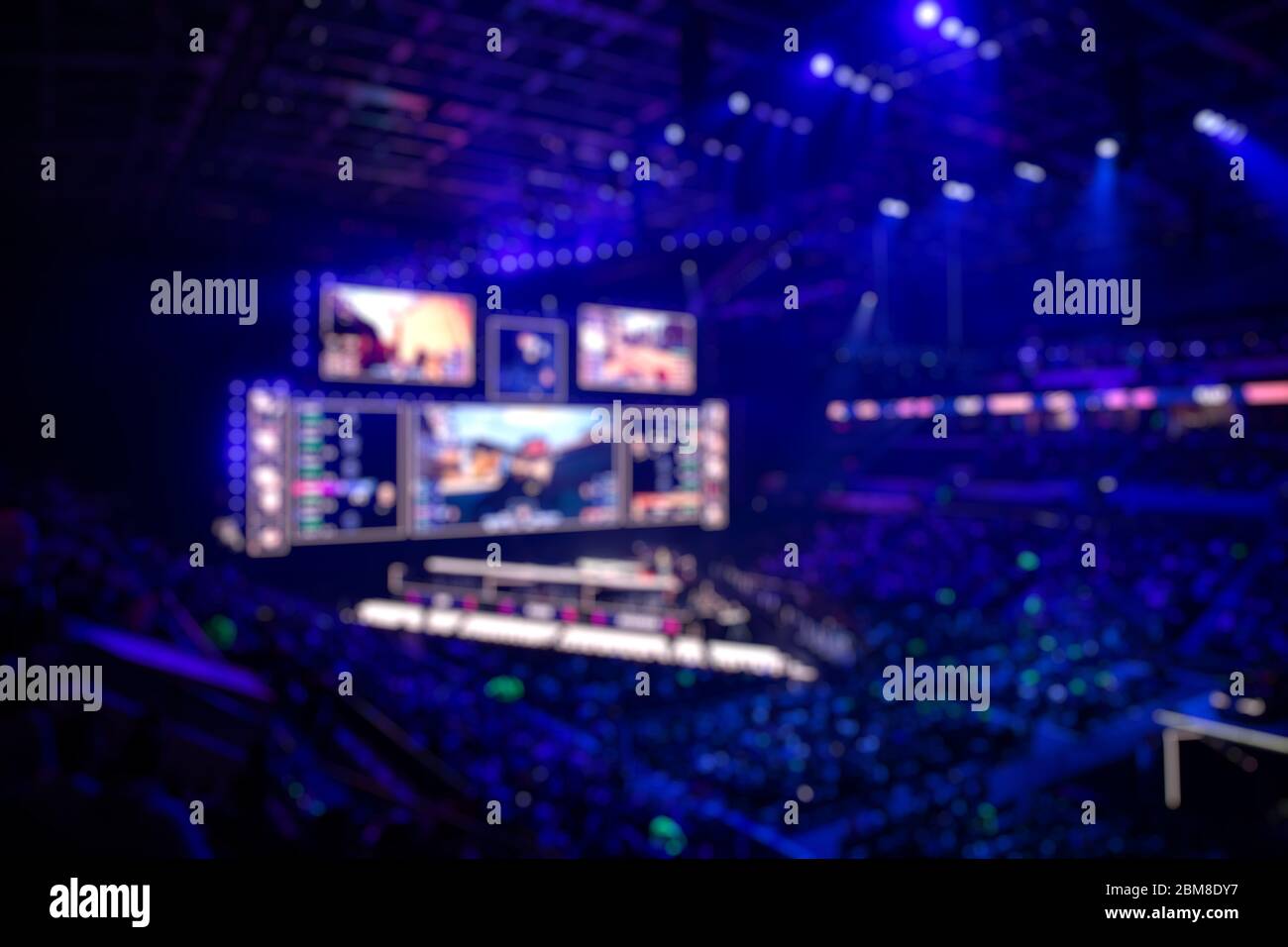 Blurred background of an esports event - Big illuminated main stage of ...