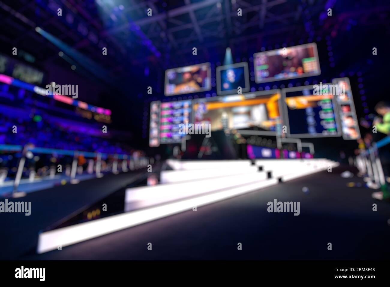 Blurred background of an esports event - Big illuminated main stage of ...