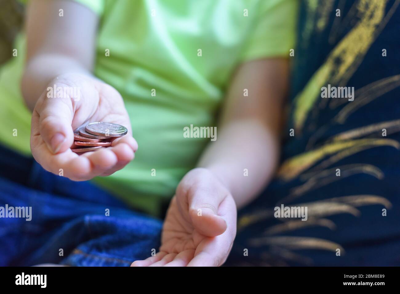 Child holding money hi-res stock photography and images - Alamy