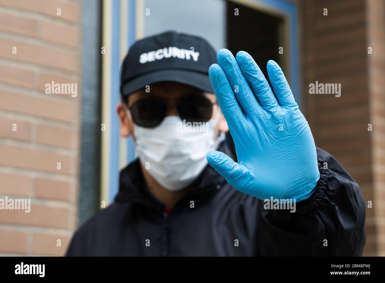 Security Guard In Uniform And Face Mask Making Stop Hand Gesture Stock ...