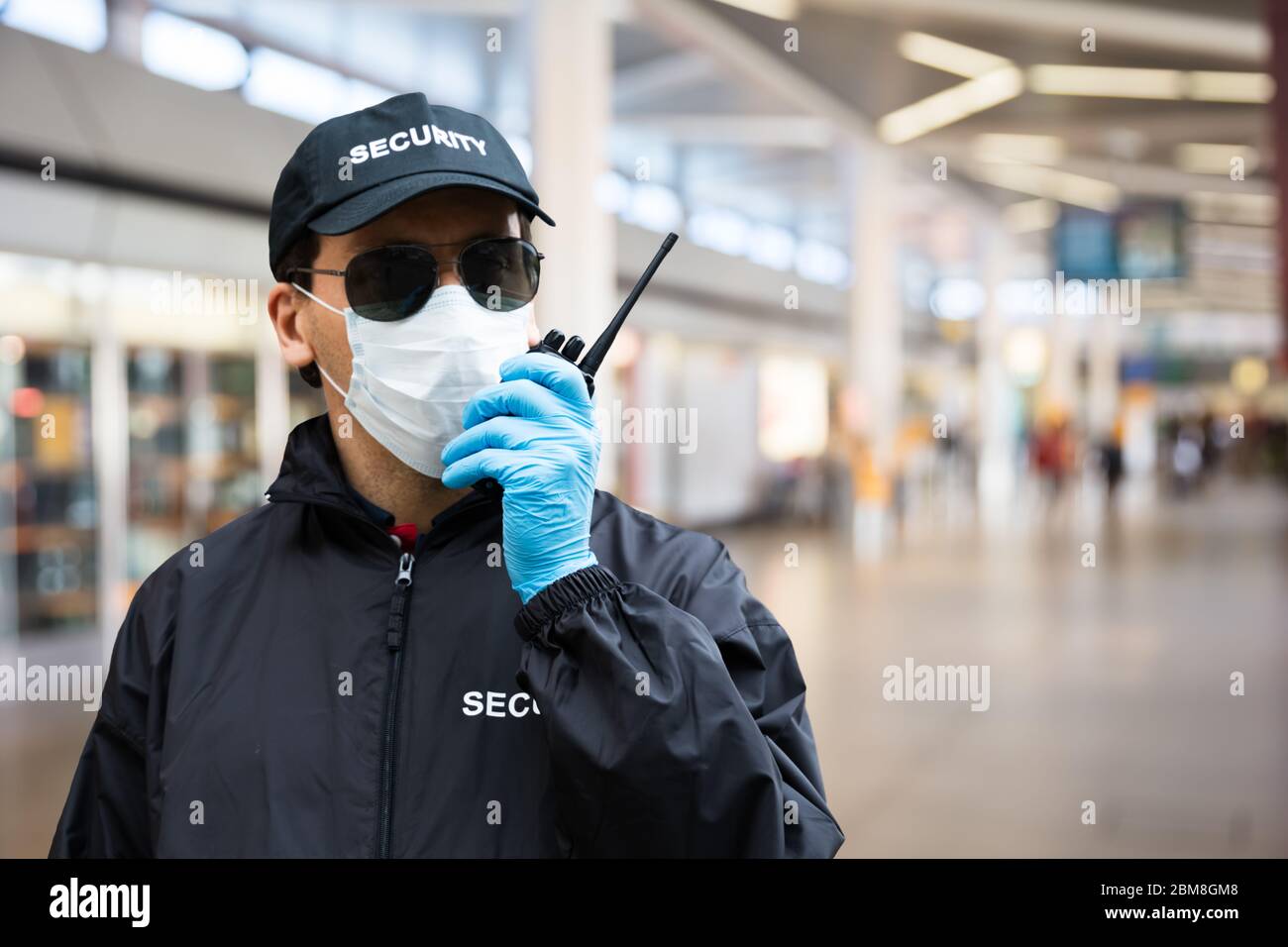 Security Guard Standing In Face Mask In Airport Terminal Stock Photo ...