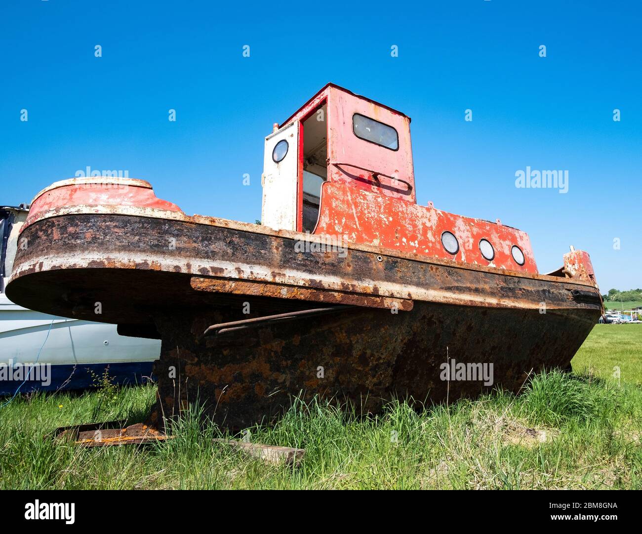 Old abandoned tug boat vessel on dry land Stock Photo - Alamy