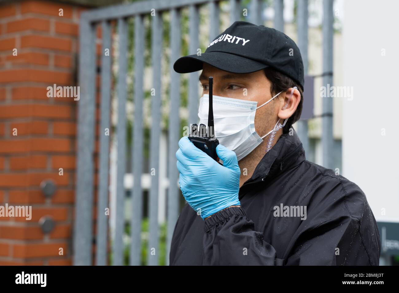 Security guard talking on radio hi-res stock photography and images - Alamy