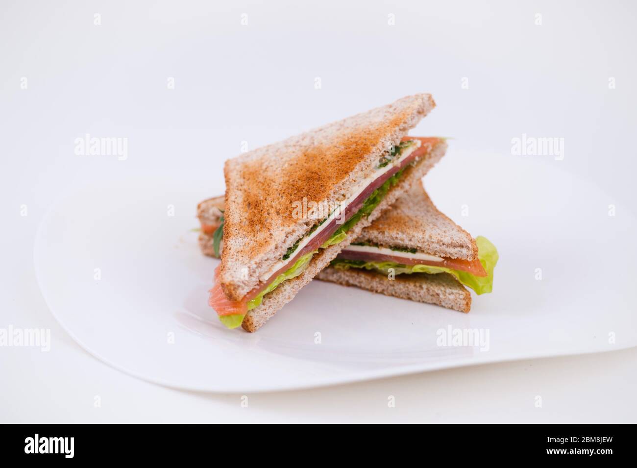 Ham sandwich on a plate on white background Stock Photo - Alamy
