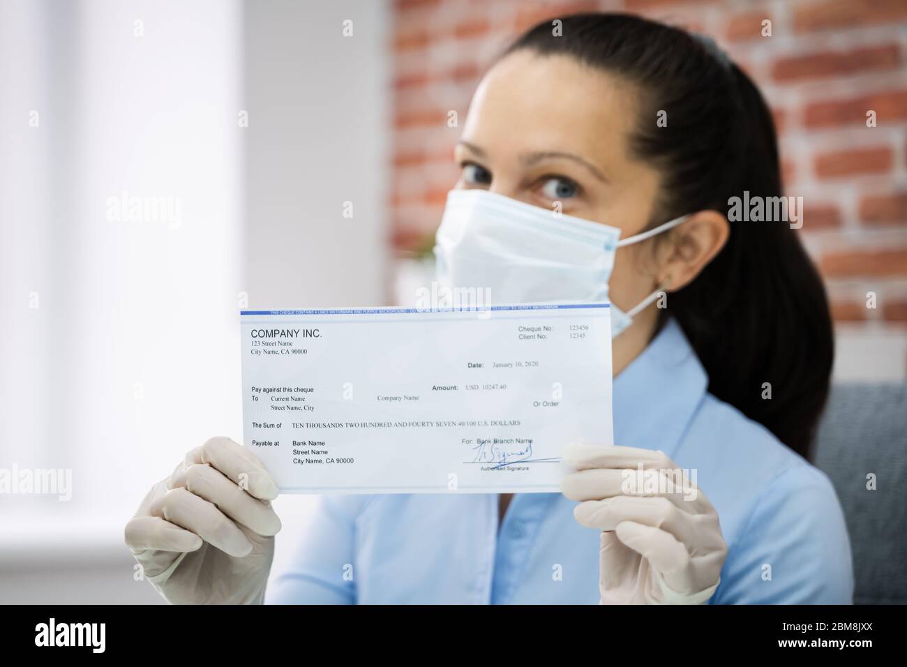 Woman cheque happy hi-res stock photography and images - Alamy