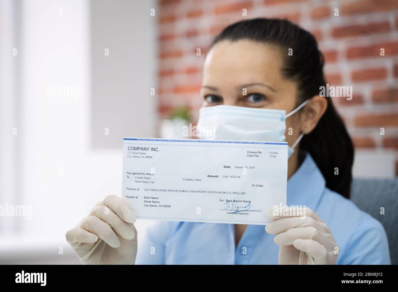 Woman In Face Mask Holding Paycheck Or Stimulus Check Stock Photo - Alamy