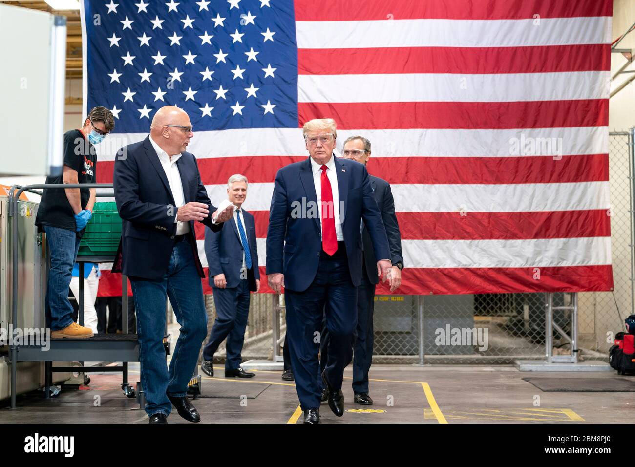 U.S. President Donald Trump, is given a tour of the mask production ...