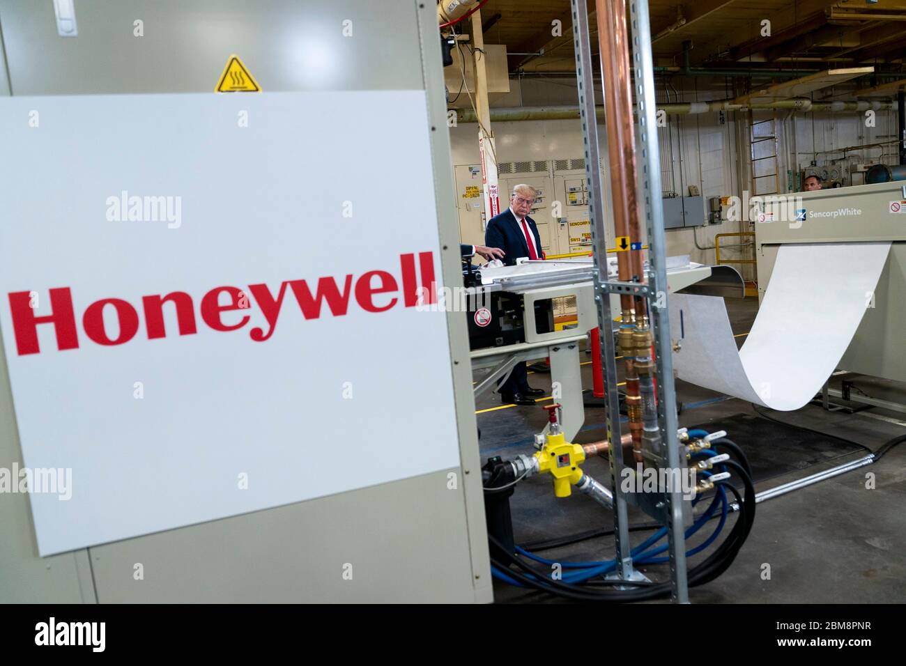 U.S. President Donald Trump, tours the mask production assembly line at ...