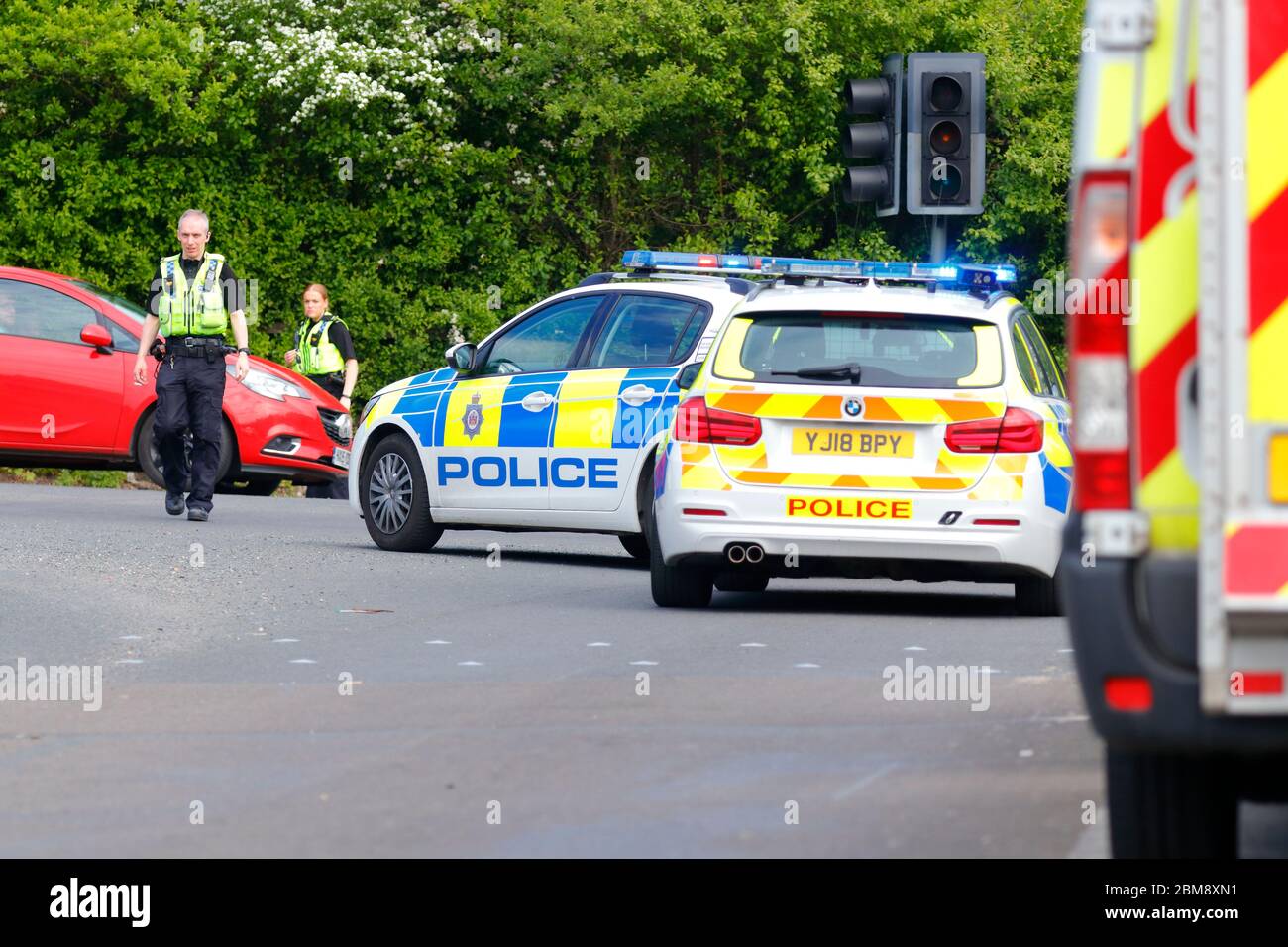 Police vehicles used as a road block, to divert traffic away from an ...