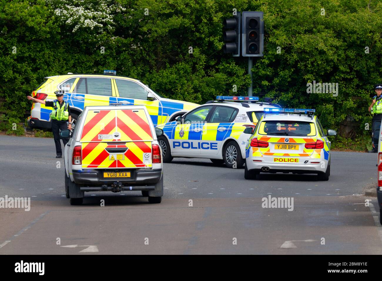 Police vehicles used as a road block, to divert traffic away from an ...