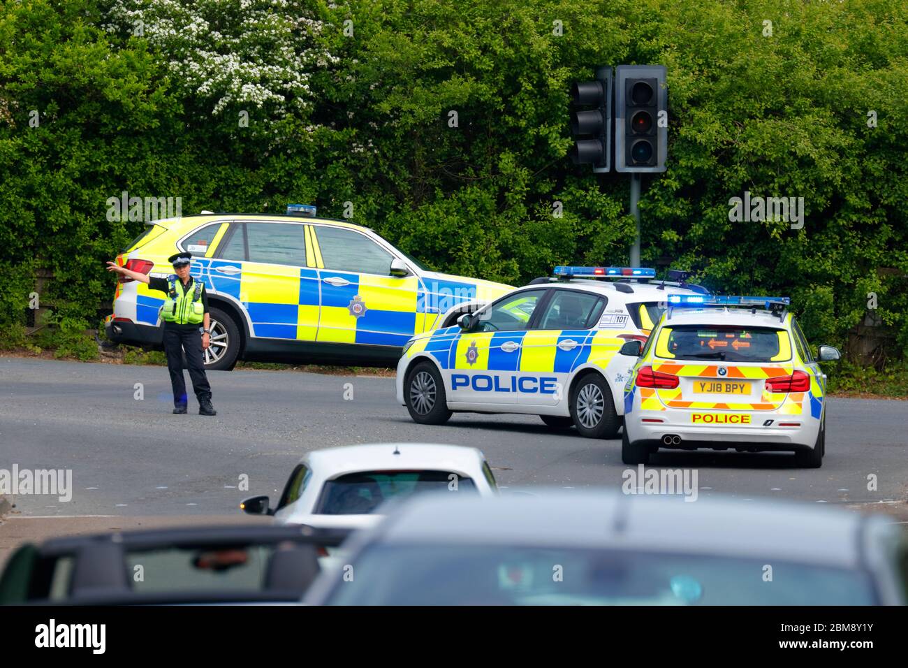 Police vehicles used as a road block, to divert traffic away from an ...