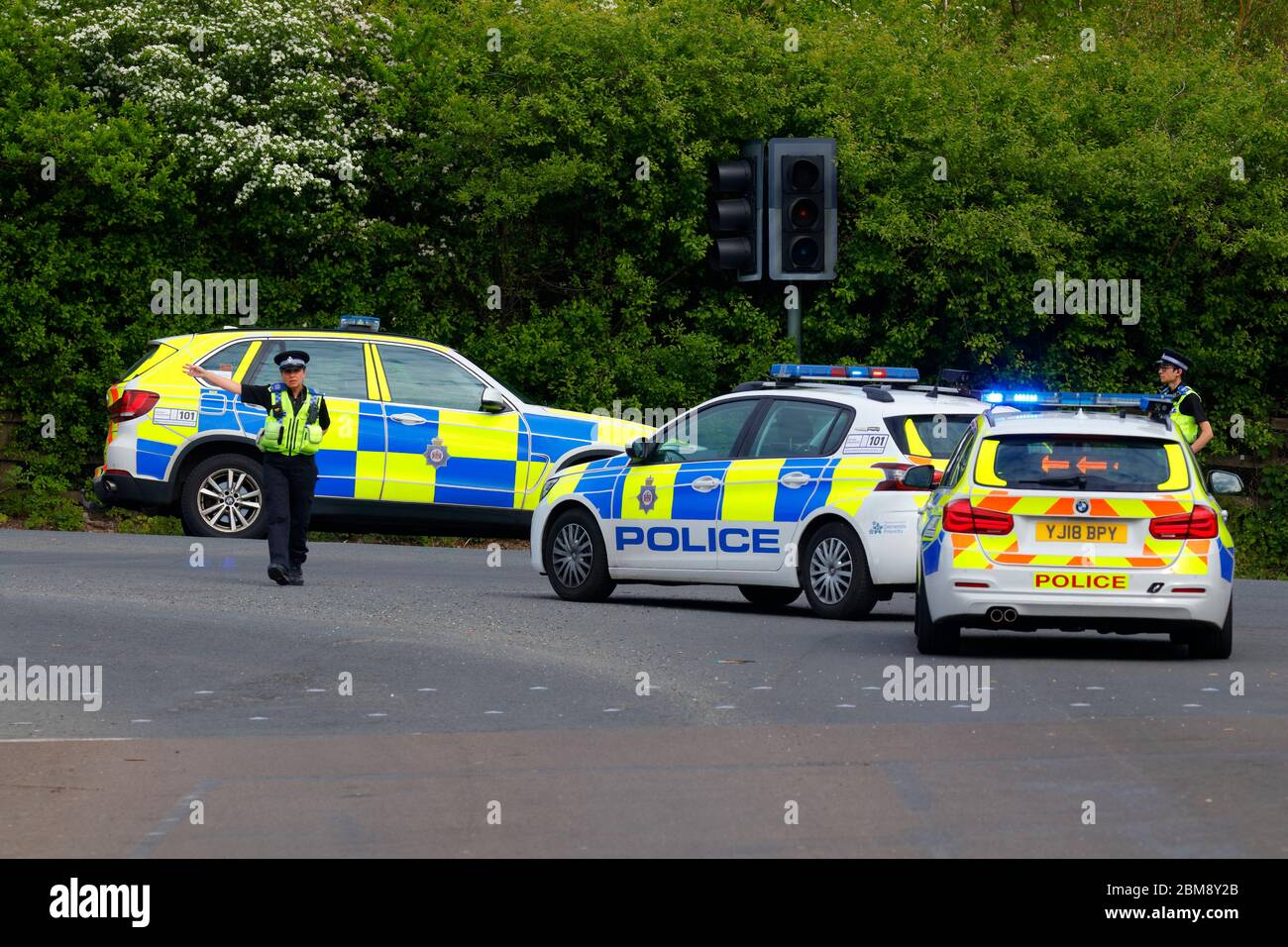Police vehicles used as a road block, to divert traffic away from an ...