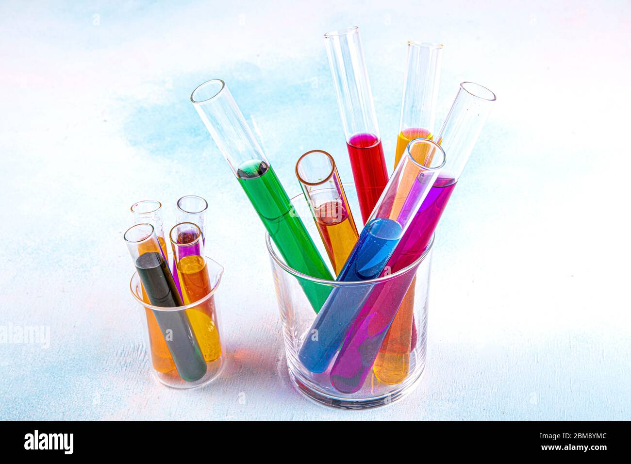 Test tubes in a rack containing rainbow colored solutions. Laboratory ...