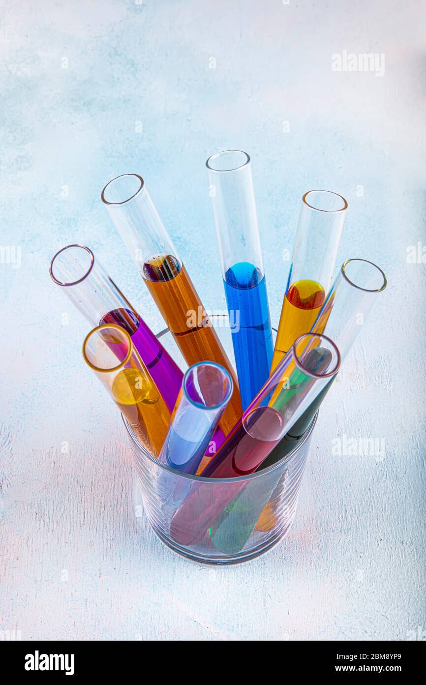 Test tubes in a rack containing rainbow colored solutions. Laboratory ...