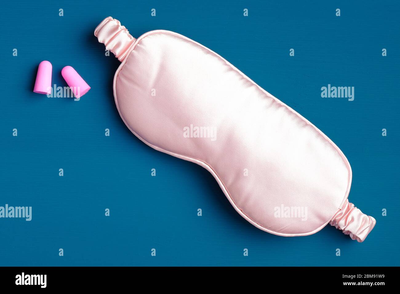 Female sleeping eye mask and ear plugs on dark blue background. Flat ...