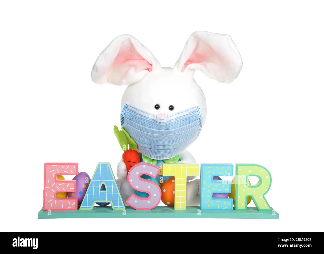 Easter bunny stuffed toy wearing a surgical medical face mask sitting ...