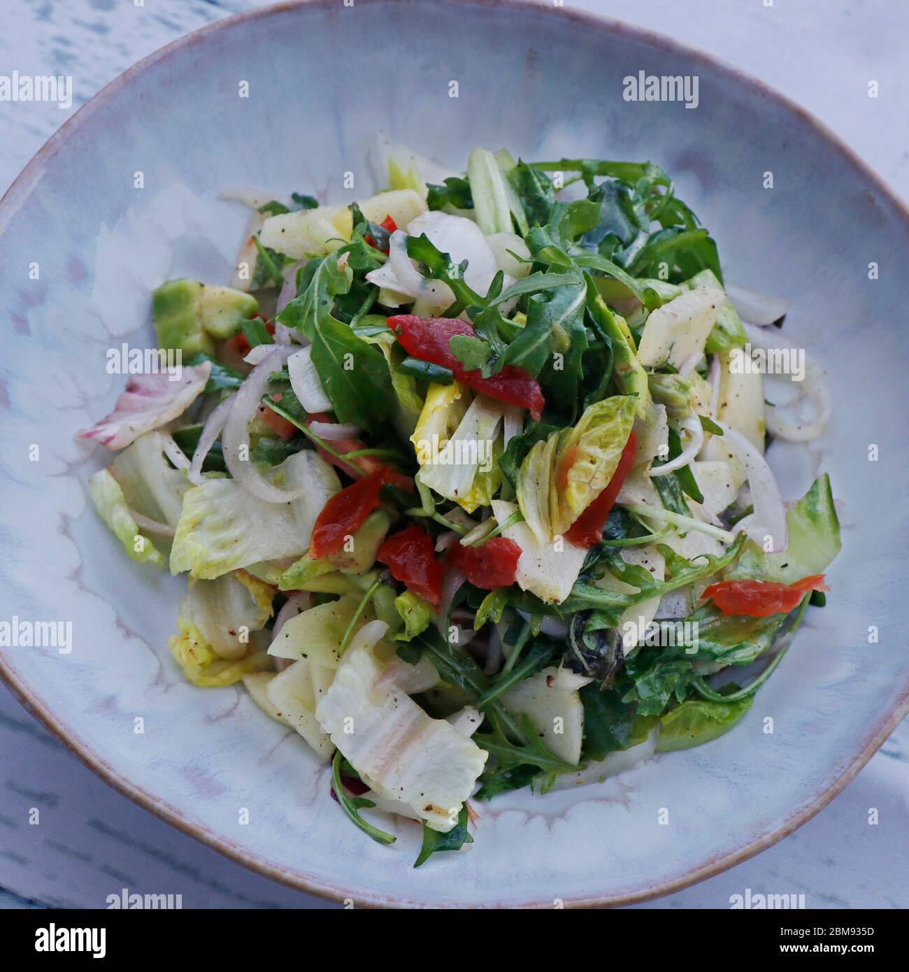 healthy vegan lunch bowl.avocado, roket leaves, romain lettuce, tomato ...