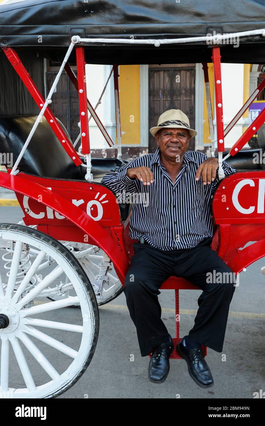 Nicaragua; Central America, Granada. Driver with his horse carriage ...