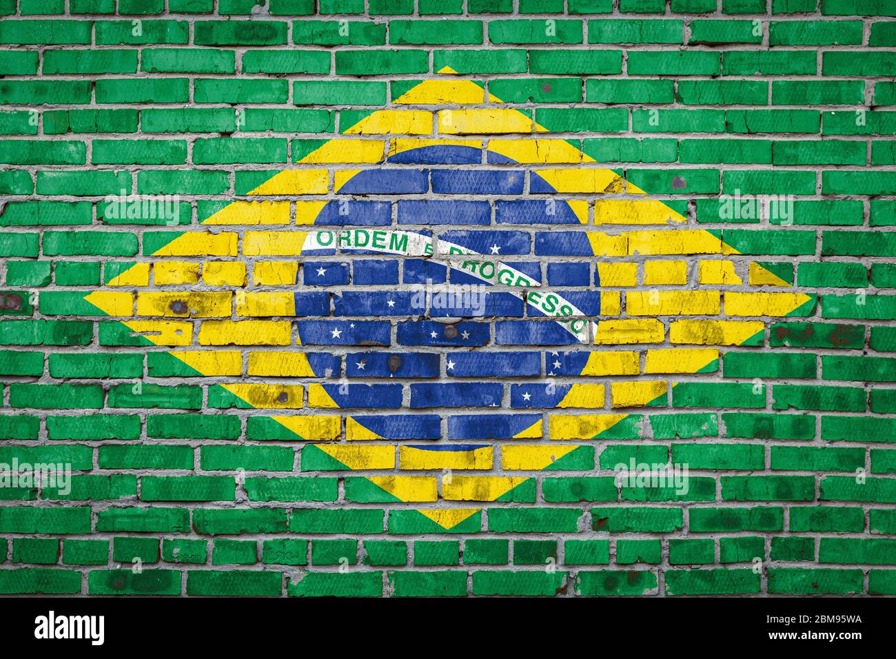 National flag of Brazil depicting in paint colors on an old brick wall ...