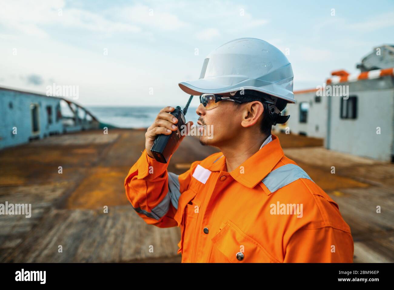 Filipino deck Officer on deck of vessel or ship , wearing PPE personal ...