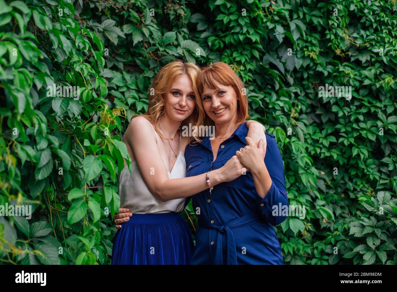 Beautiful Mother And Her Grown Up Daughter Hugging Each Other On A