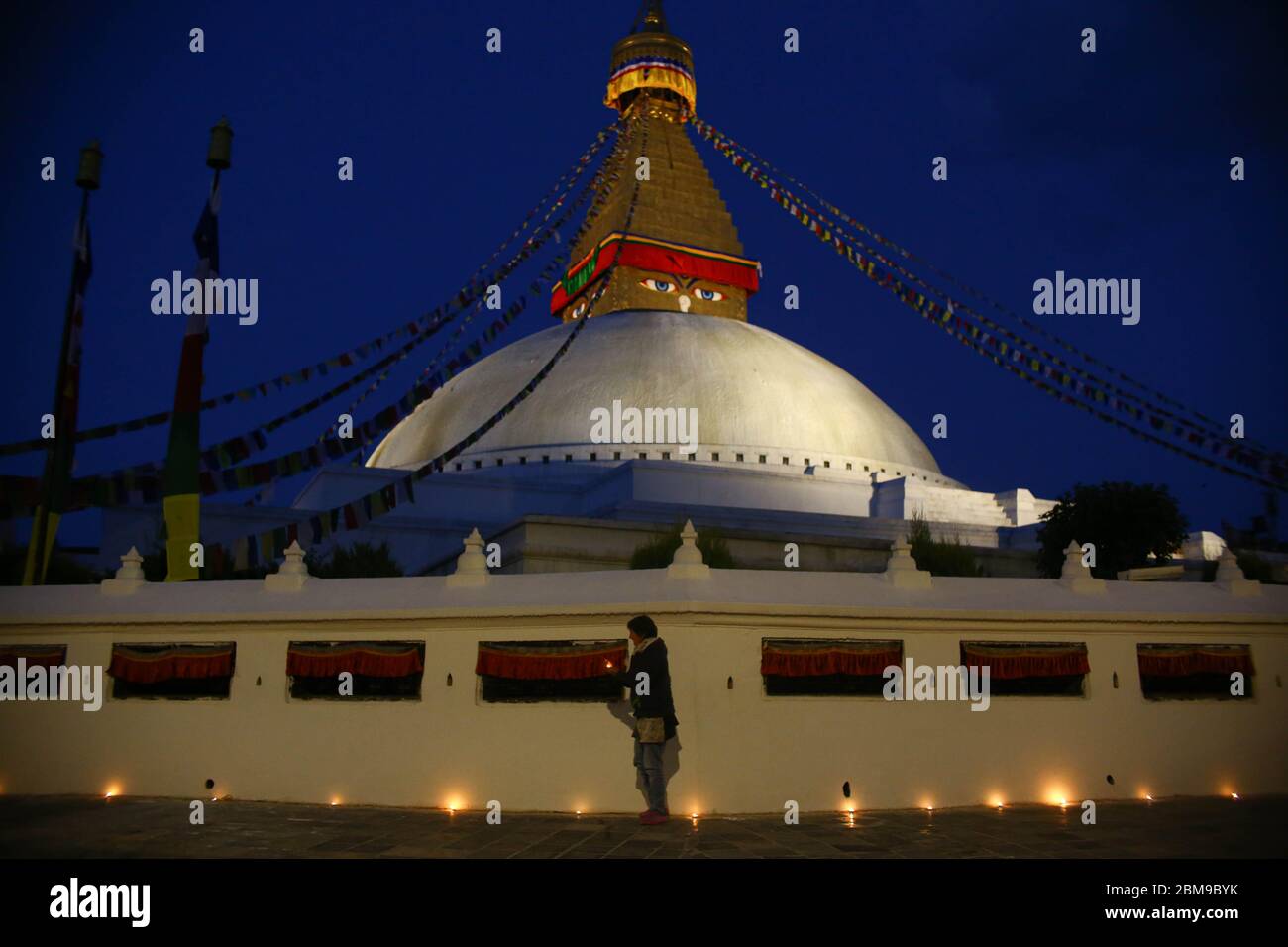 Kathmandu, Nepal. 7th May, 2020. A devotee lights the oil lamp to mark ...